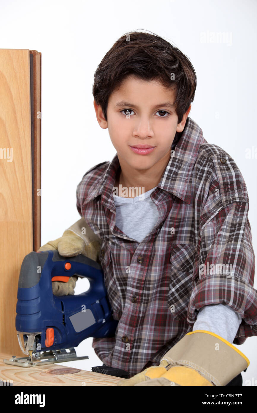 Little boy with wood saw Stock Photo - Alamy
