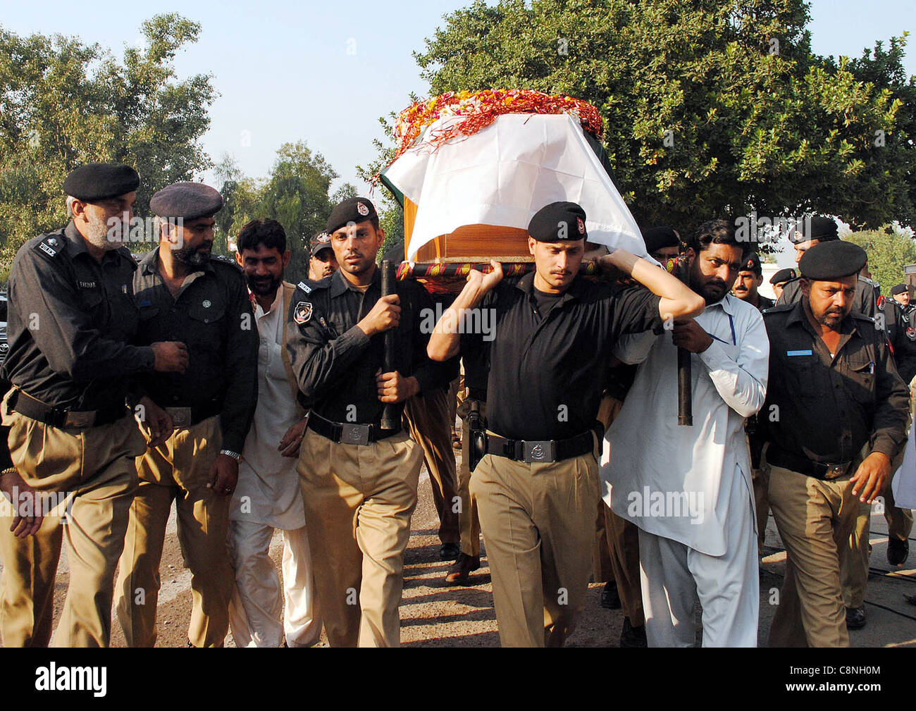 Policemen carry coffin of a policeman who was killed in Nowshera Stock ...