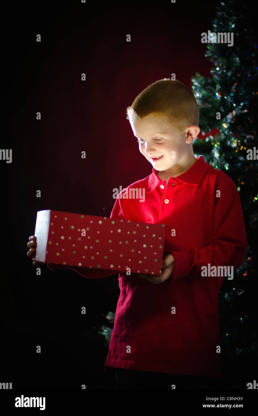 Young boy receiving a Christmas present Stock Photo - Alamy