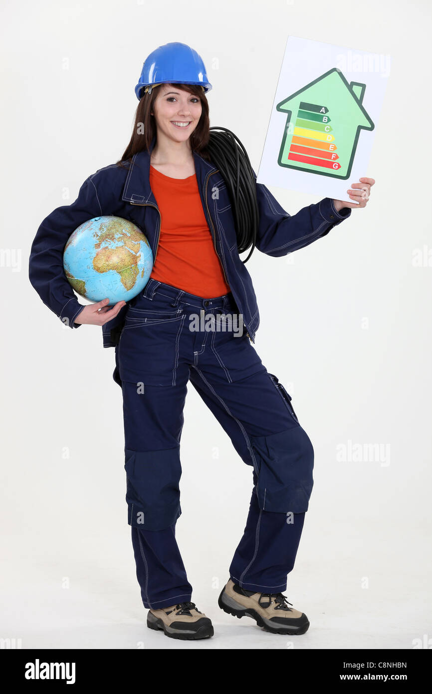 female heating engineer holding globe Stock Photo - Alamy