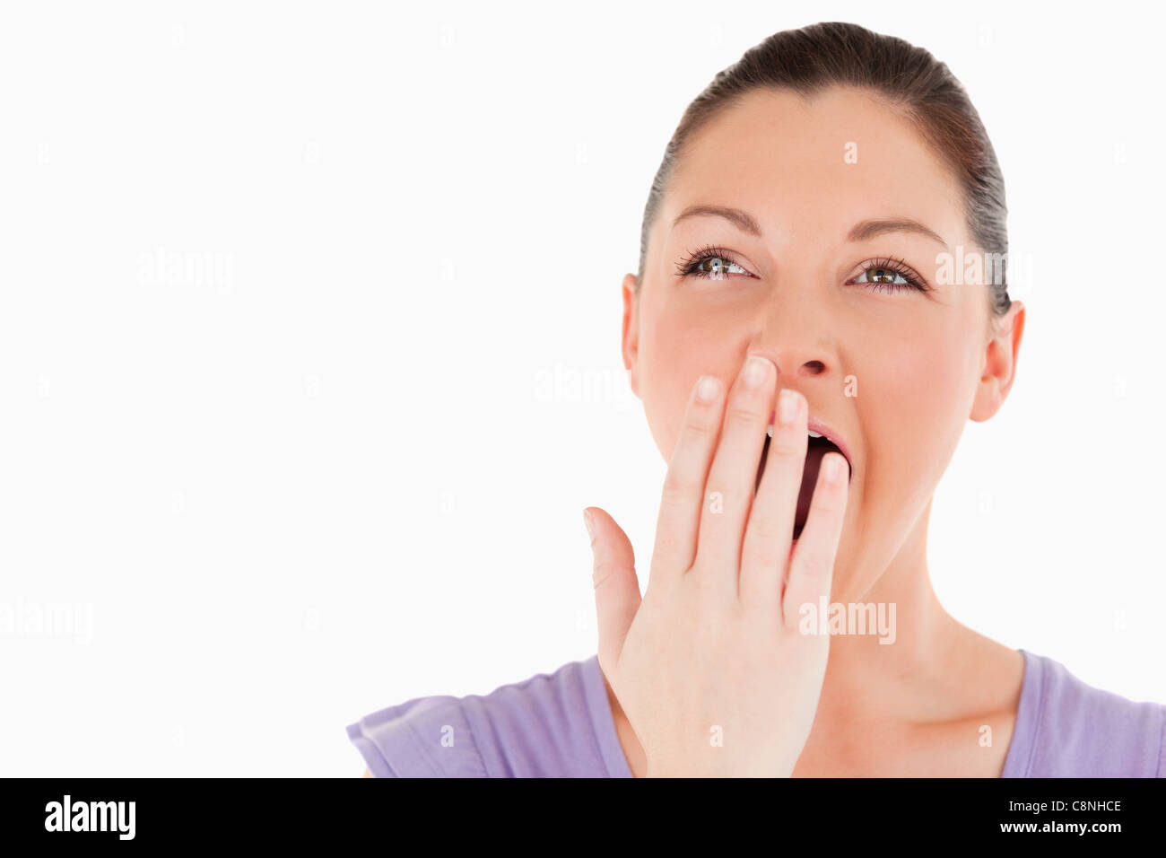 Portrait of a beautiful woman yawning while standing Stock Photo - Alamy