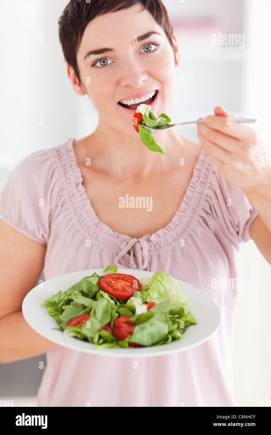 Woman eating salad Stock Photo - Alamy