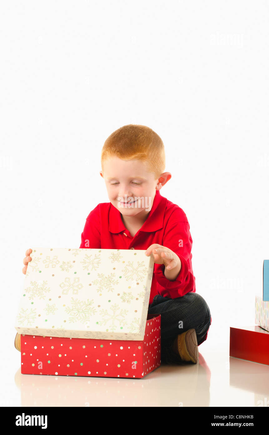 Child opening Christmas gift box Stock Photo - Alamy