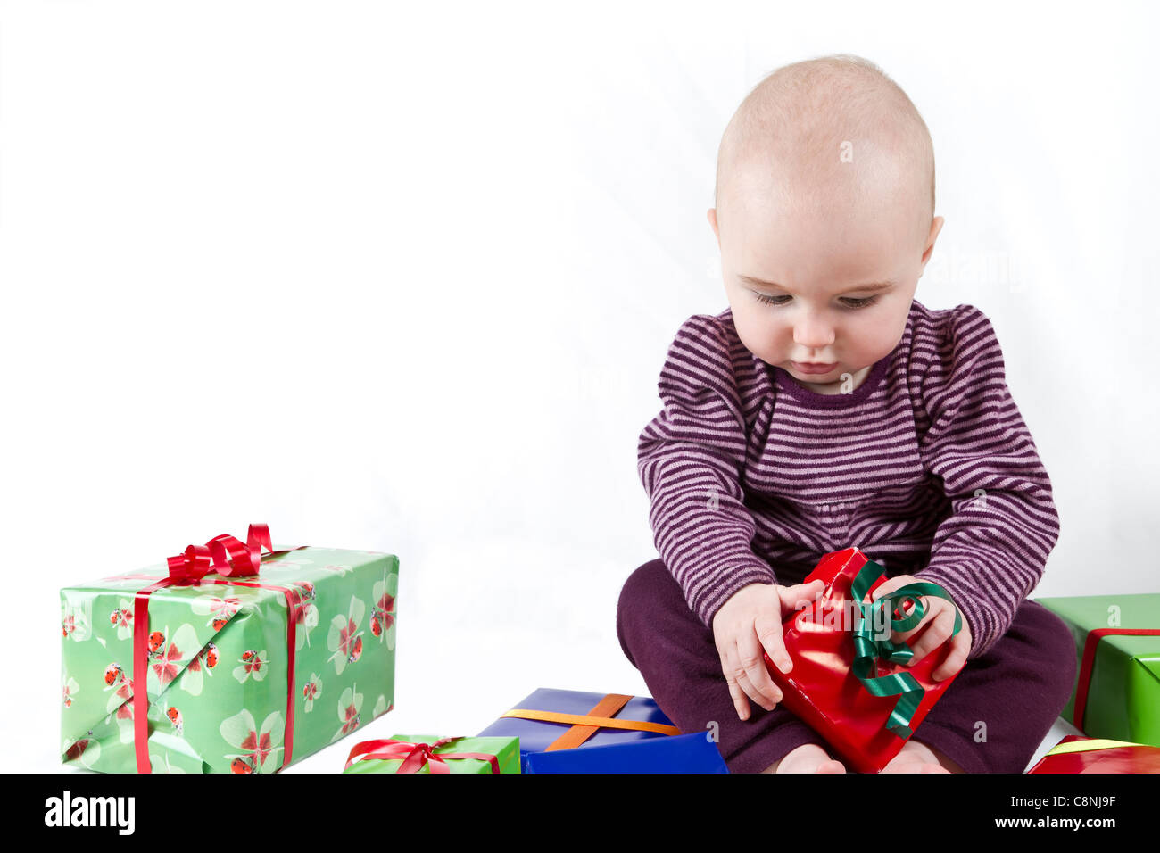 young child unpacking presents. white background Stock Photo - Alamy