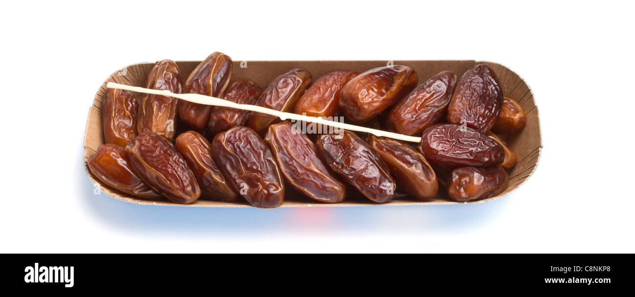 Cardboard tray of date fruits with skewer on white background Stock ...