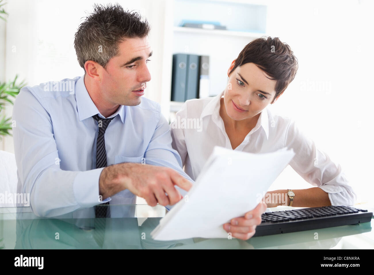 Colleagues reading documents Stock Photo - Alamy