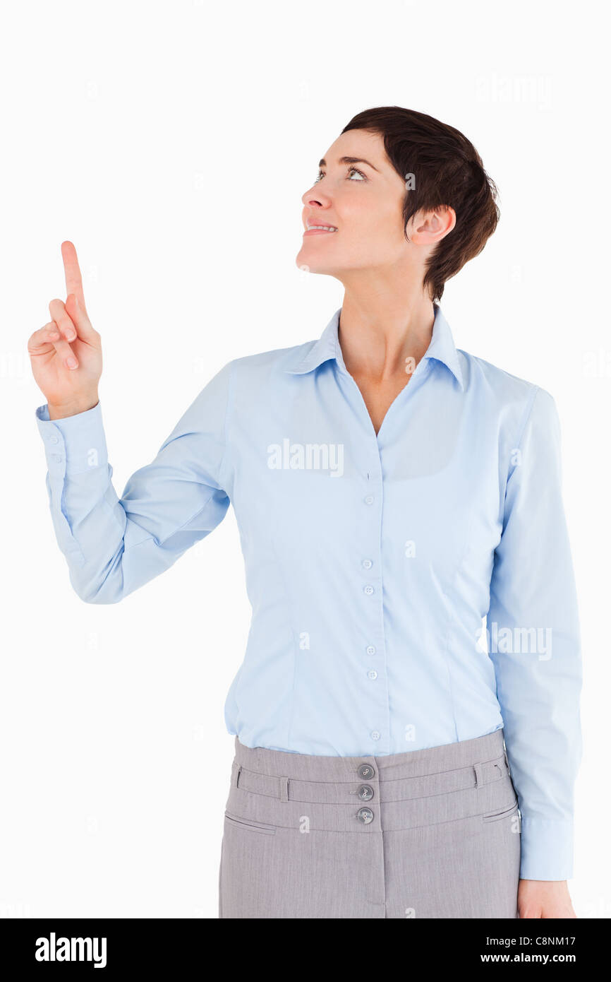 Portrait of a woman pointing at copy space Stock Photo - Alamy