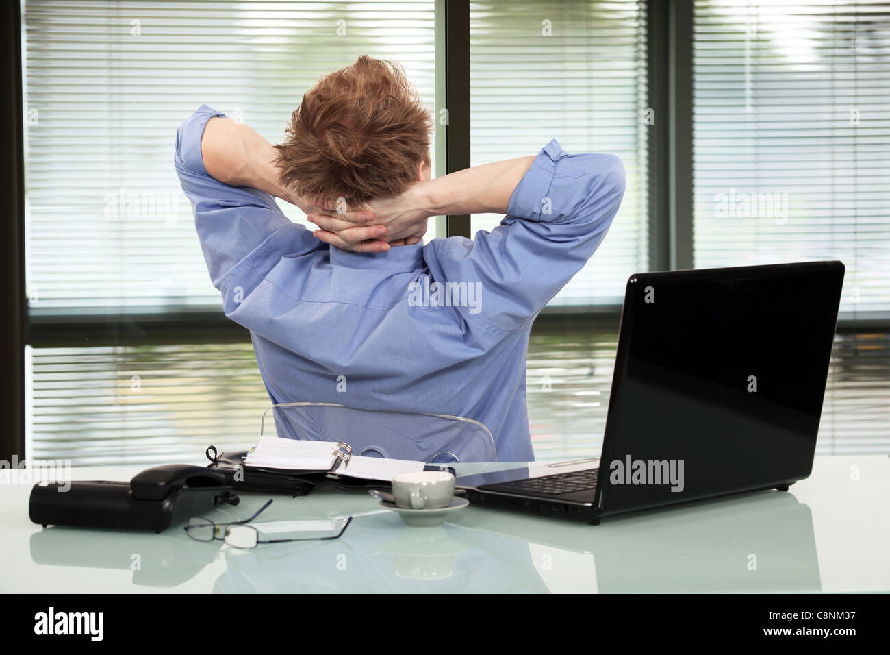 Employee resting on his workplace Stock Photo - Alamy