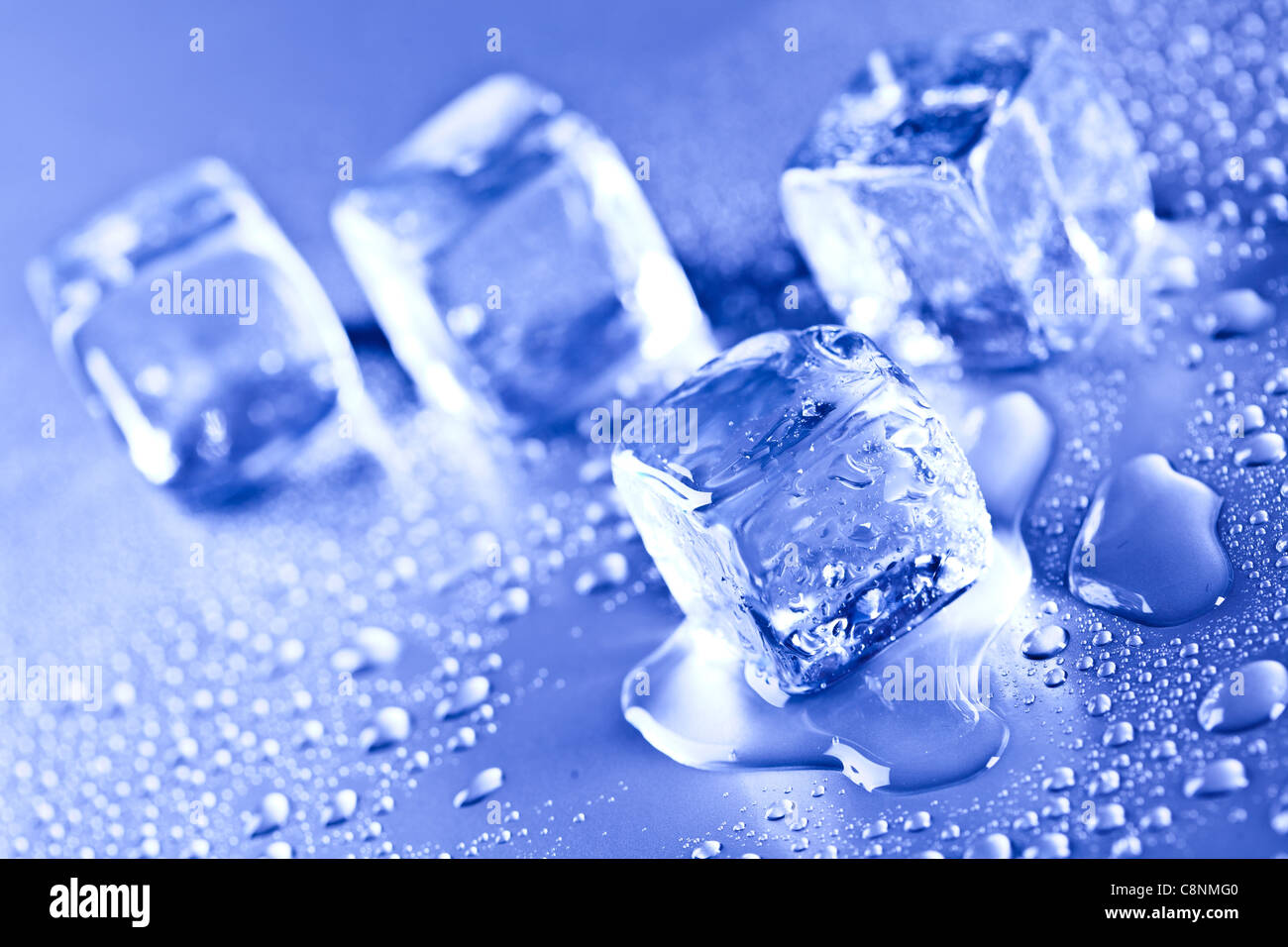 ice cubes and water drops on the blue background Stock Photo - Alamy
