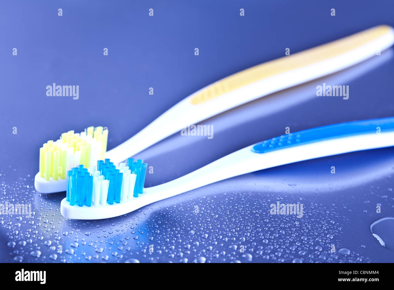 dental care and tooth brushes on the water drops Stock Photo - Alamy
