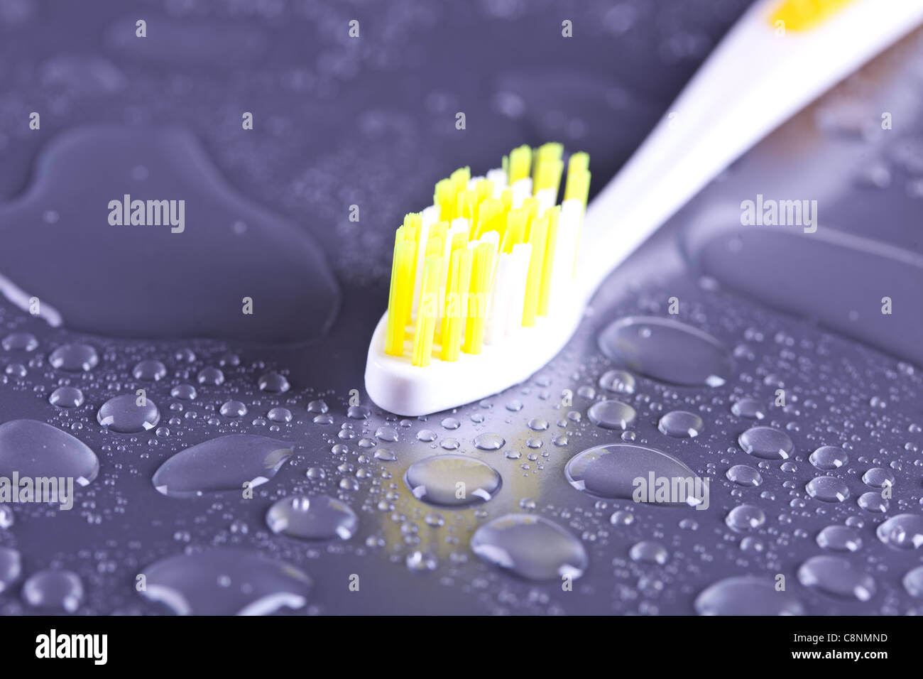 dental care and tooth brushes on the water drops Stock Photo - Alamy