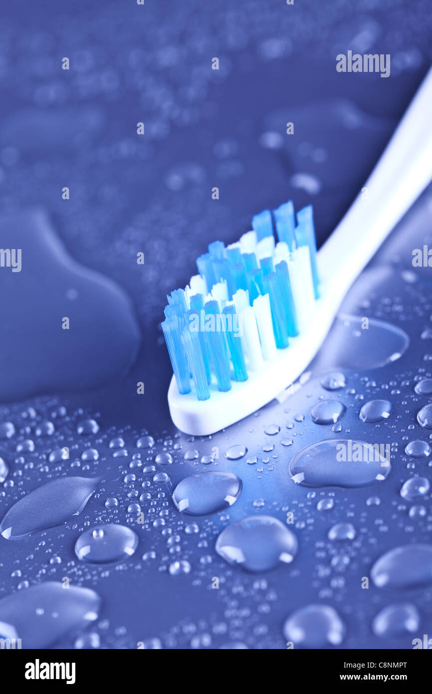 dental care and tooth brushes on the water drops Stock Photo - Alamy