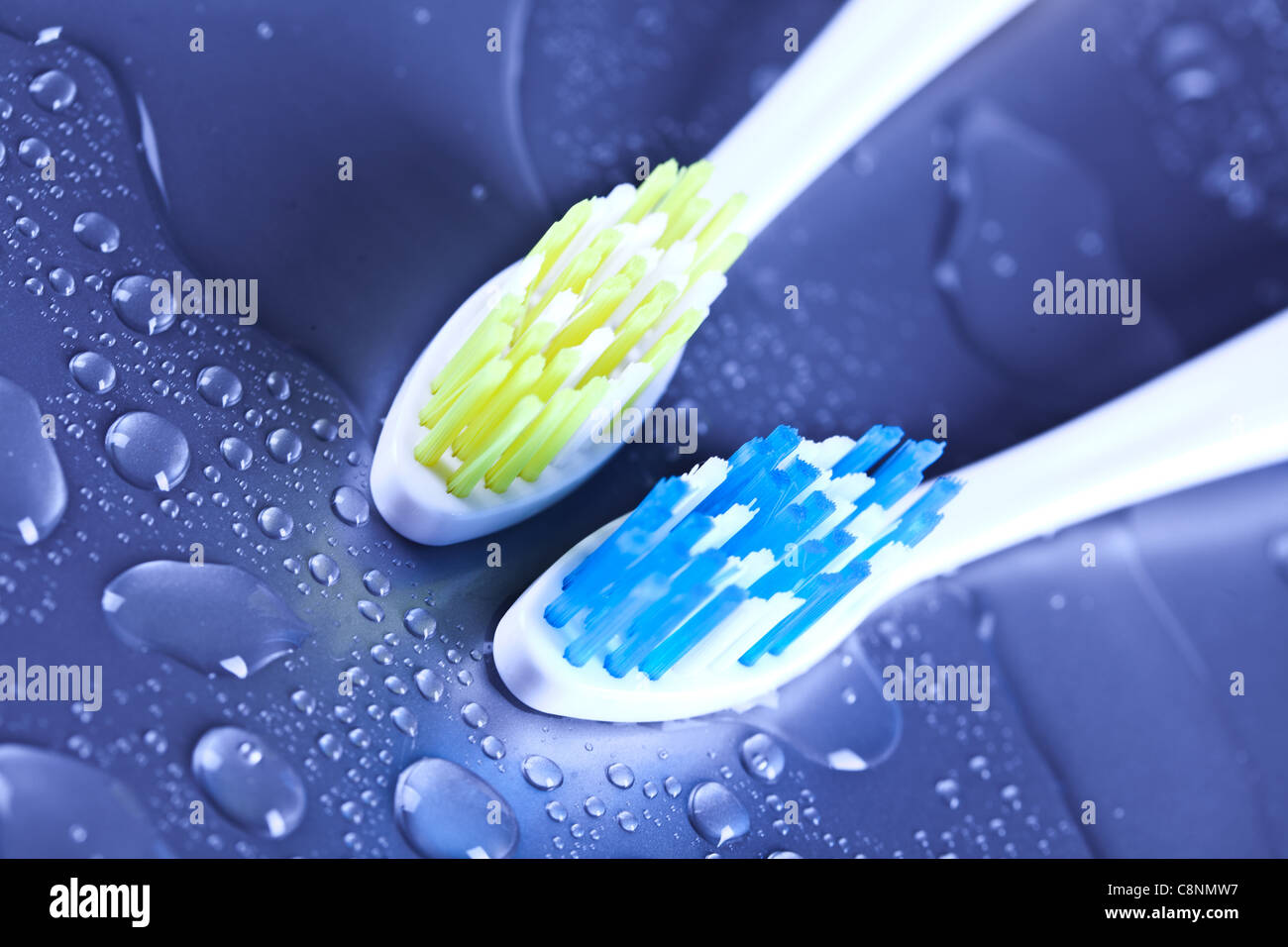 dental care and tooth brushes on the water drops Stock Photo - Alamy