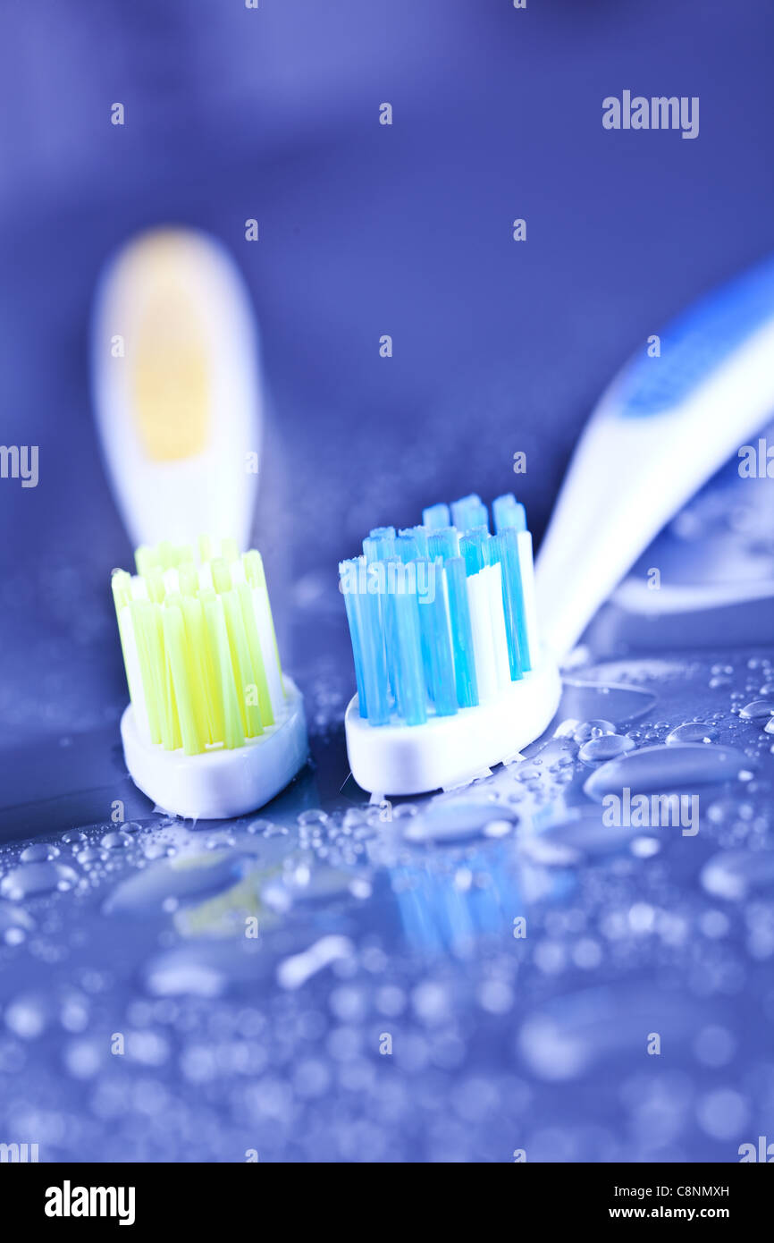 dental care and tooth brushes on the water drops Stock Photo - Alamy