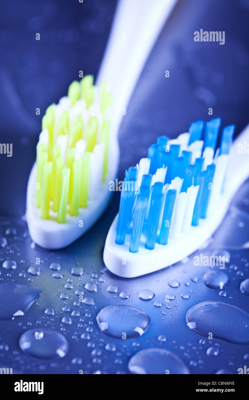 dental care and tooth brushes on the water drops Stock Photo - Alamy