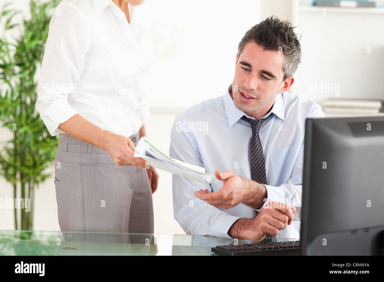 Businessman receiving document from secretary hi-res stock photography ...
