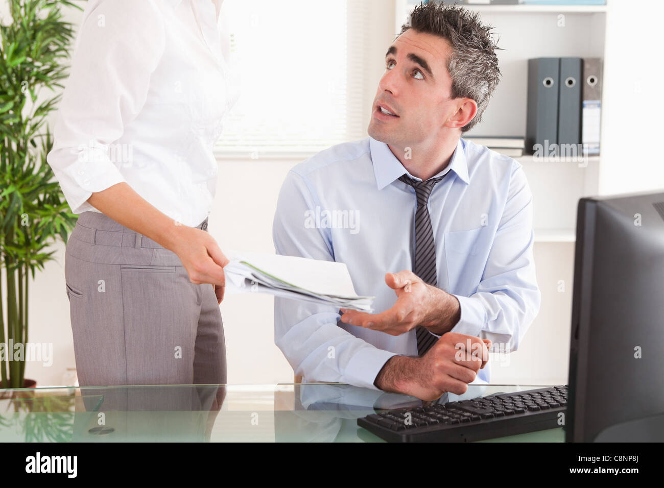 Manager receiving a document from his secretary Stock Photo - Alamy