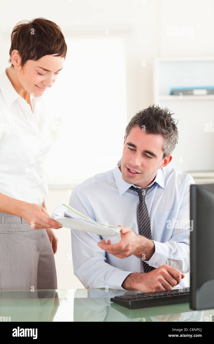 Portrait of a manager receiving a document from his employee Stock ...