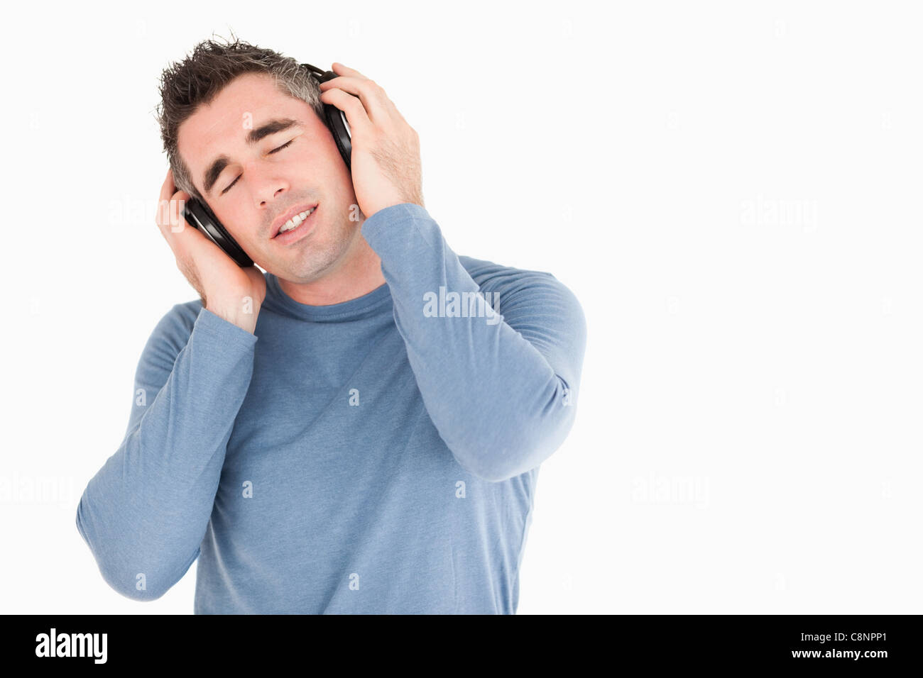 Handsome man listening to music Stock Photo - Alamy