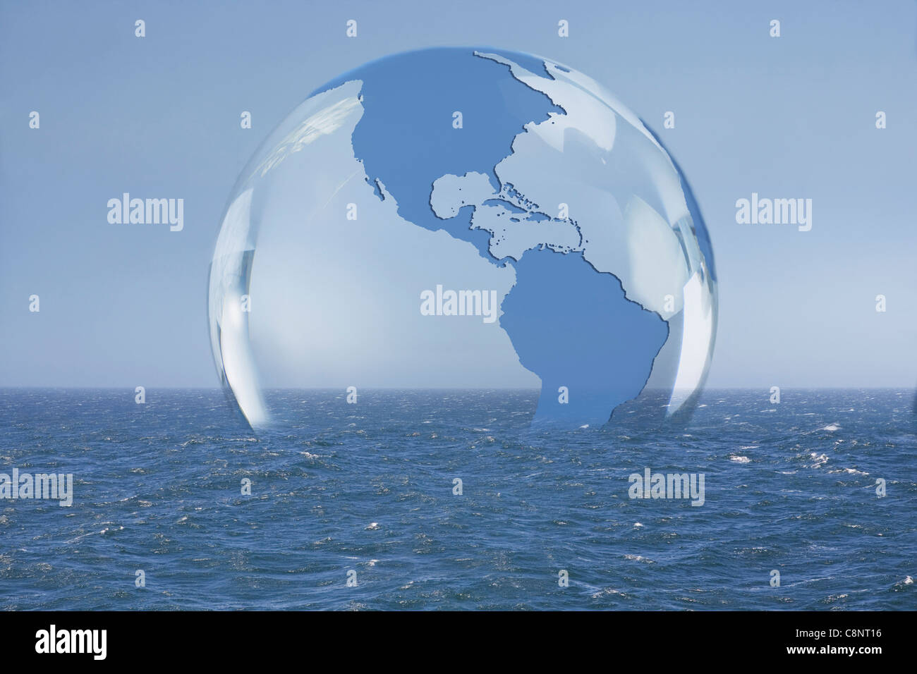 Transparent globe floating on ocean Stock Photo - Alamy