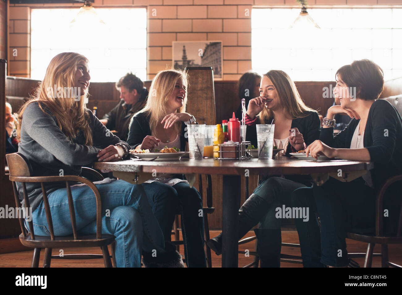 Caucasian teenagers eating together in restaurant Stock Photo - Alamy