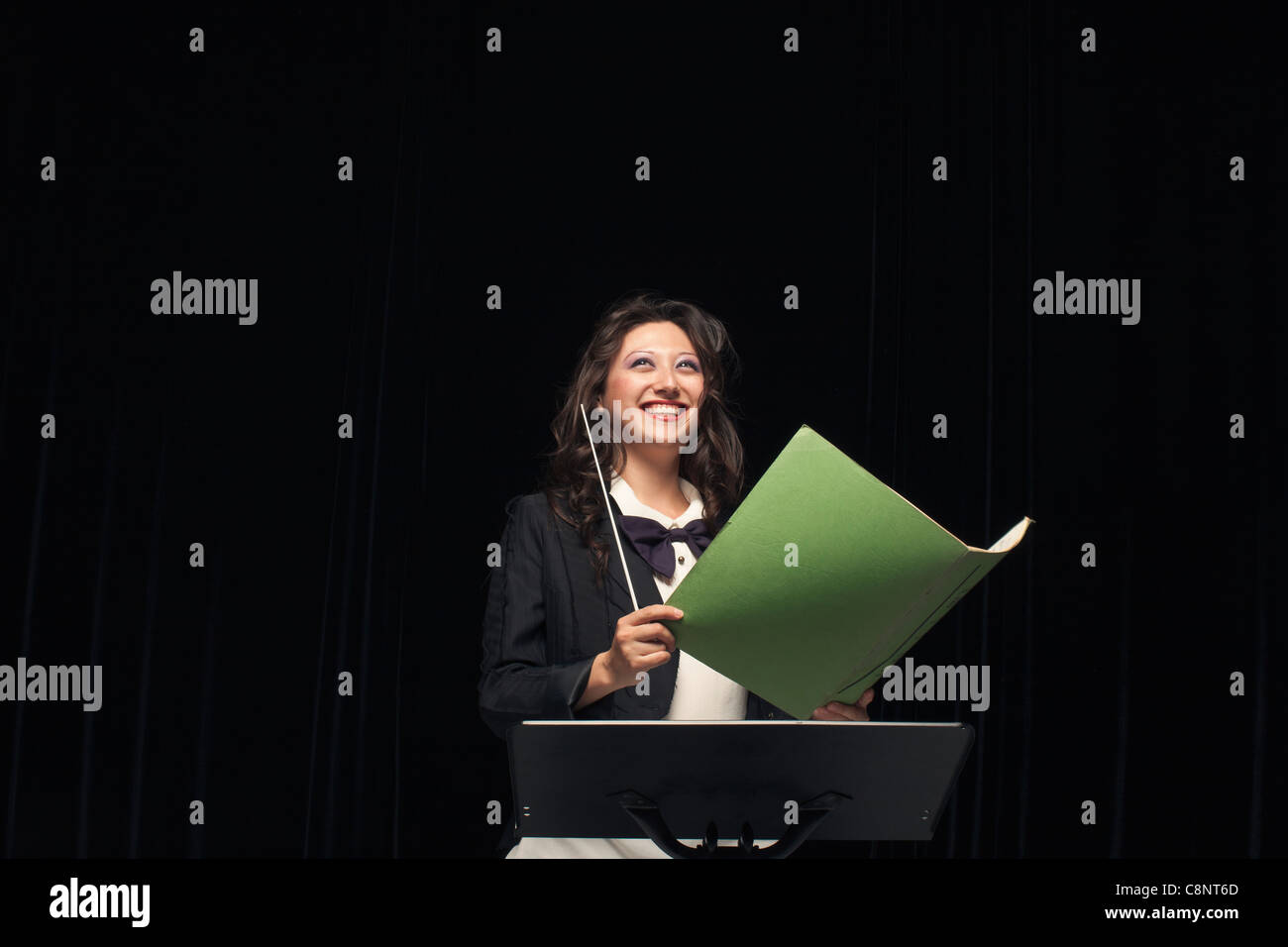 Smiling mixed race conductor holding folder Stock Photo - Alamy