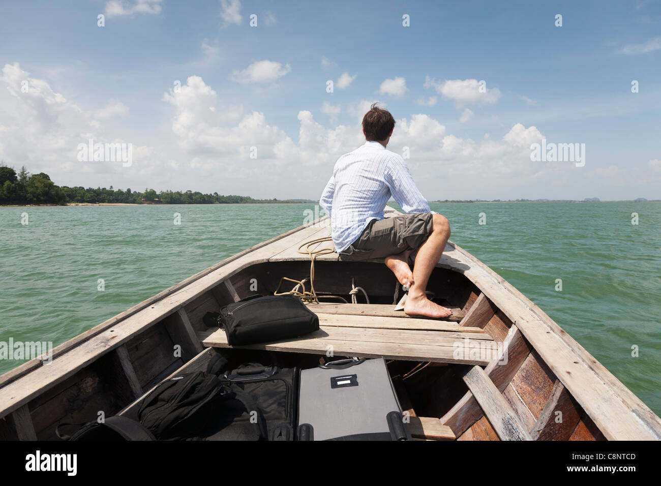 Caucasian businessman riding in boat Stock Photo - Alamy