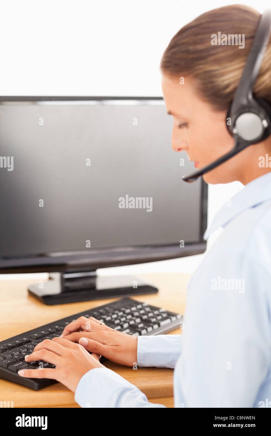 Secretary with a headset working with computer Stock Photo - Alamy