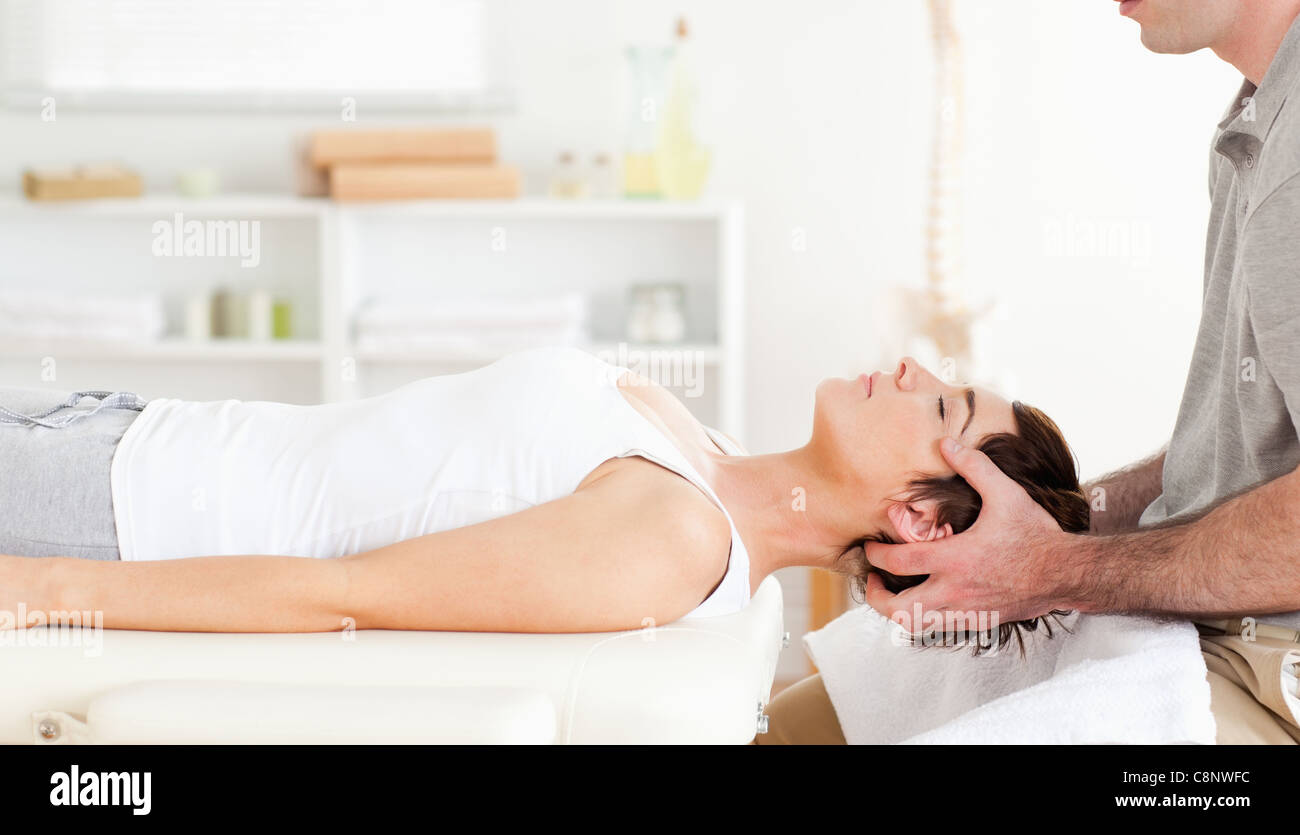 Chiropractor stretching a cute woman Stock Photo - Alamy