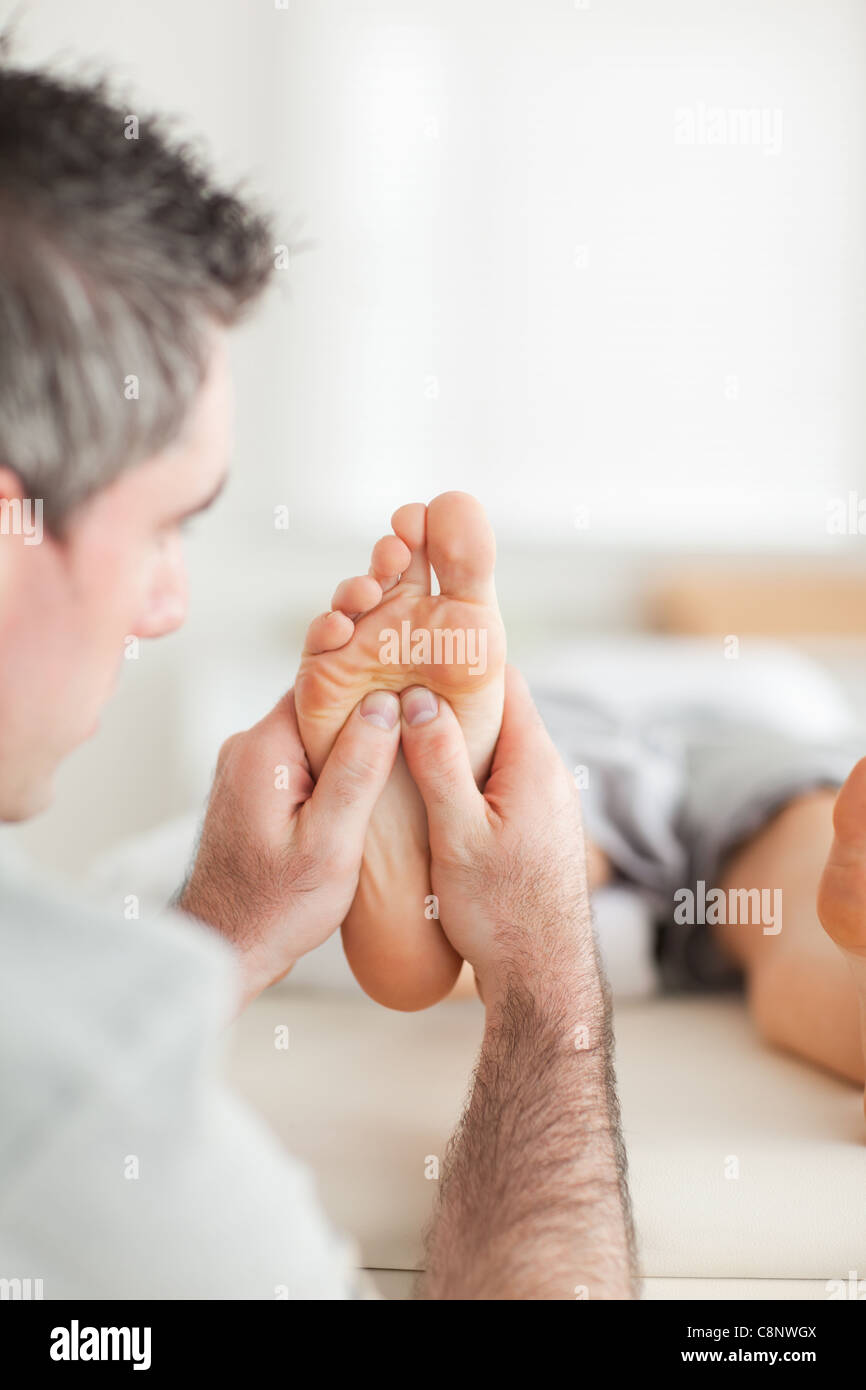 Man doing a reflexology massage Stock Photo - Alamy