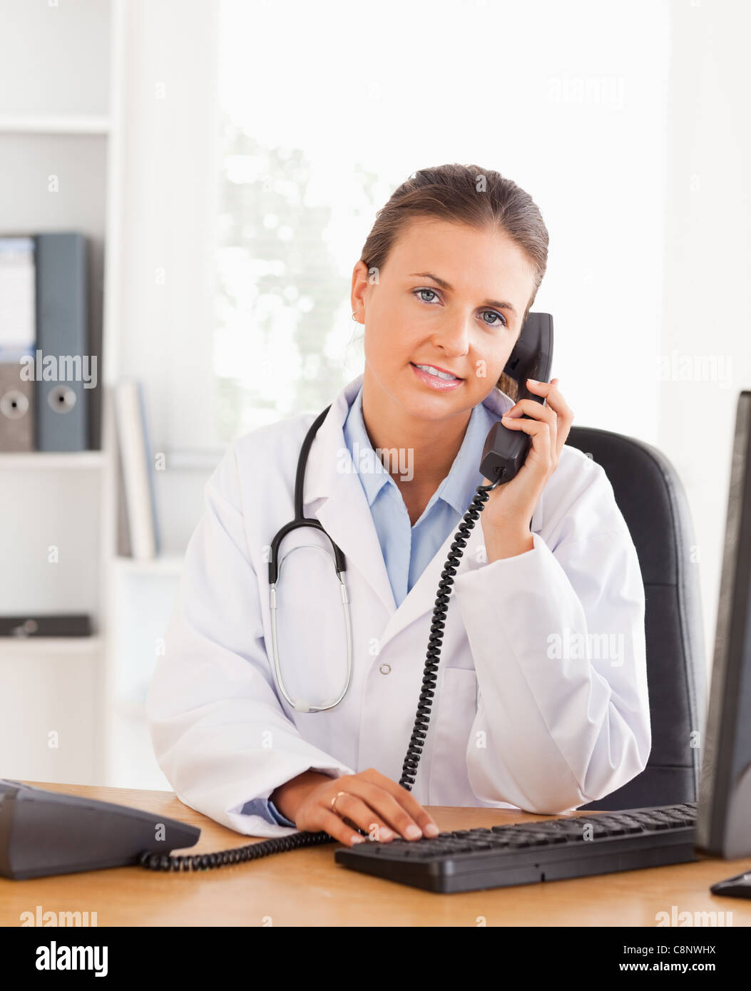 Portrait of a serious female doctor on the phone Stock Photo - Alamy