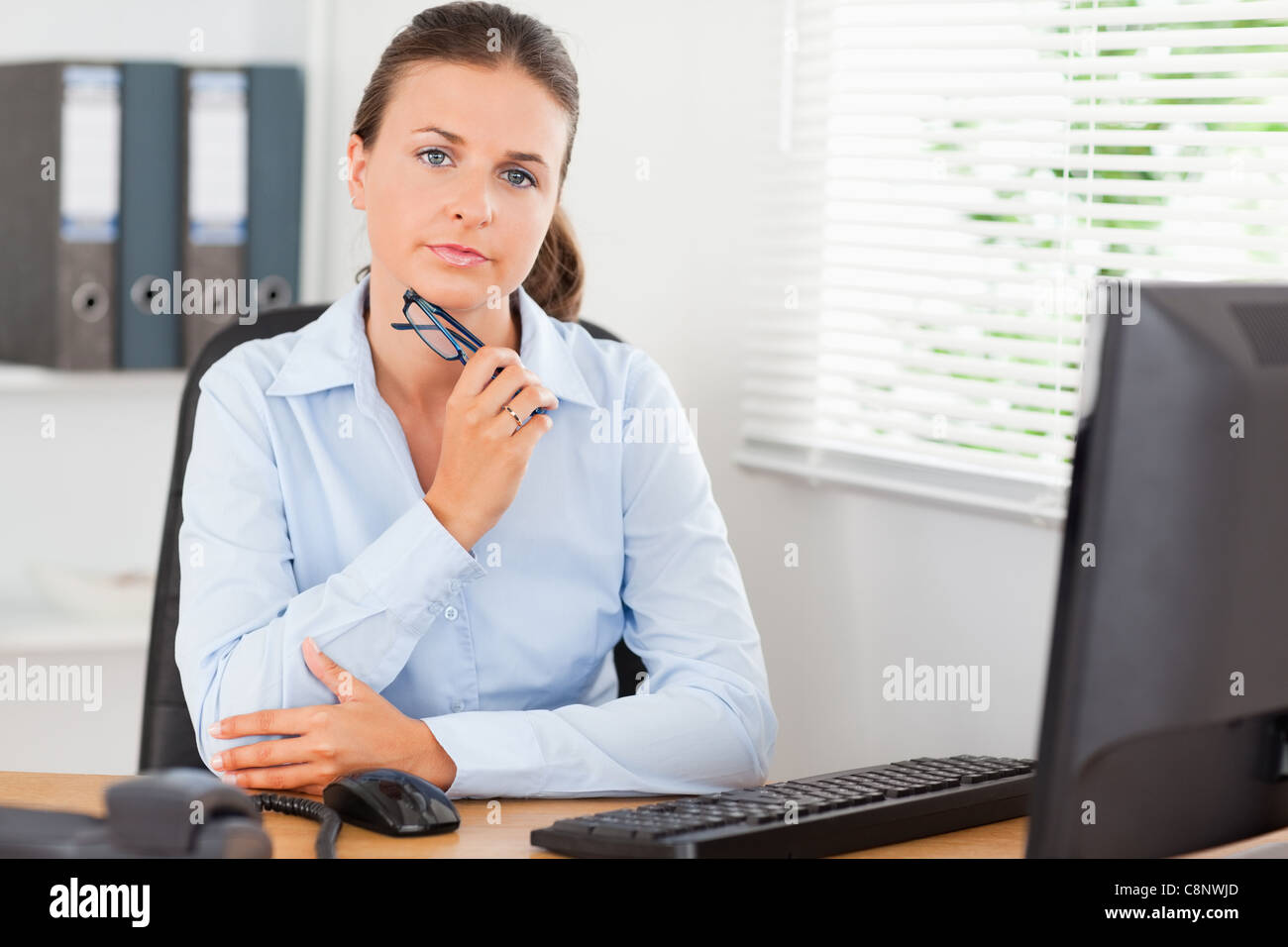 Serious working woman posing Stock Photo - Alamy