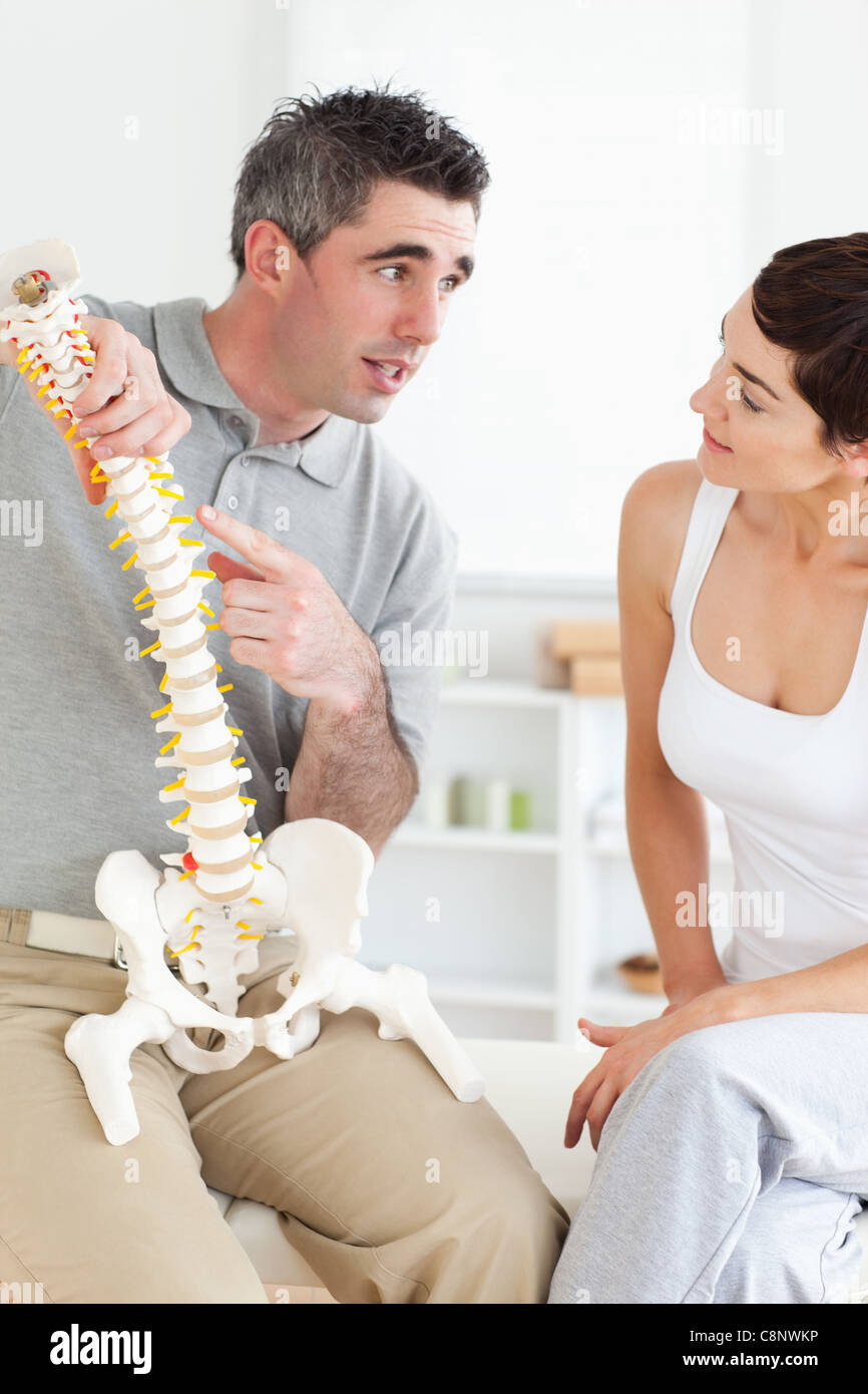 Chiropractor explaining the spine to his patient Stock Photo - Alamy