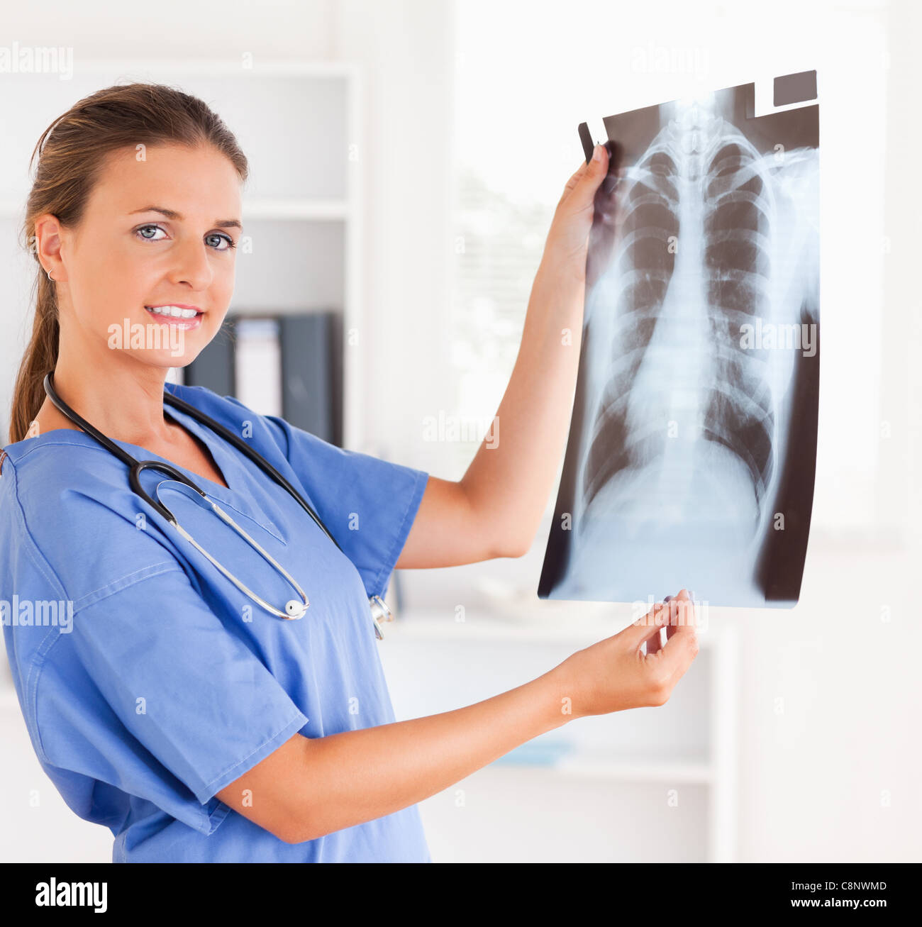 Gorgeous doctor with stethoscope and x-ray looking into camera Stock ...
