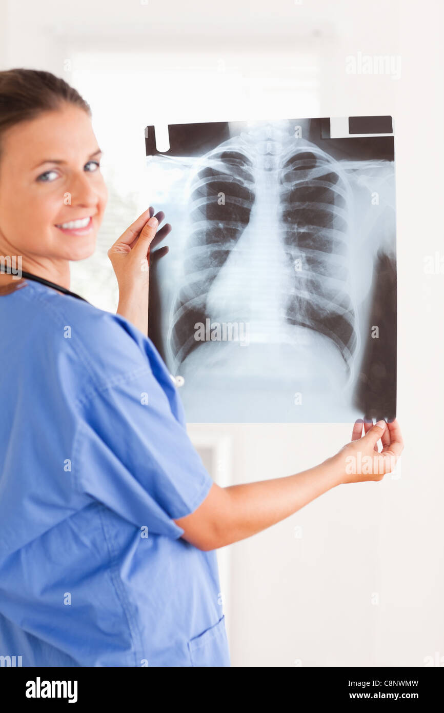 Charming doctor smiling at the camera holding a x-ray Stock Photo - Alamy