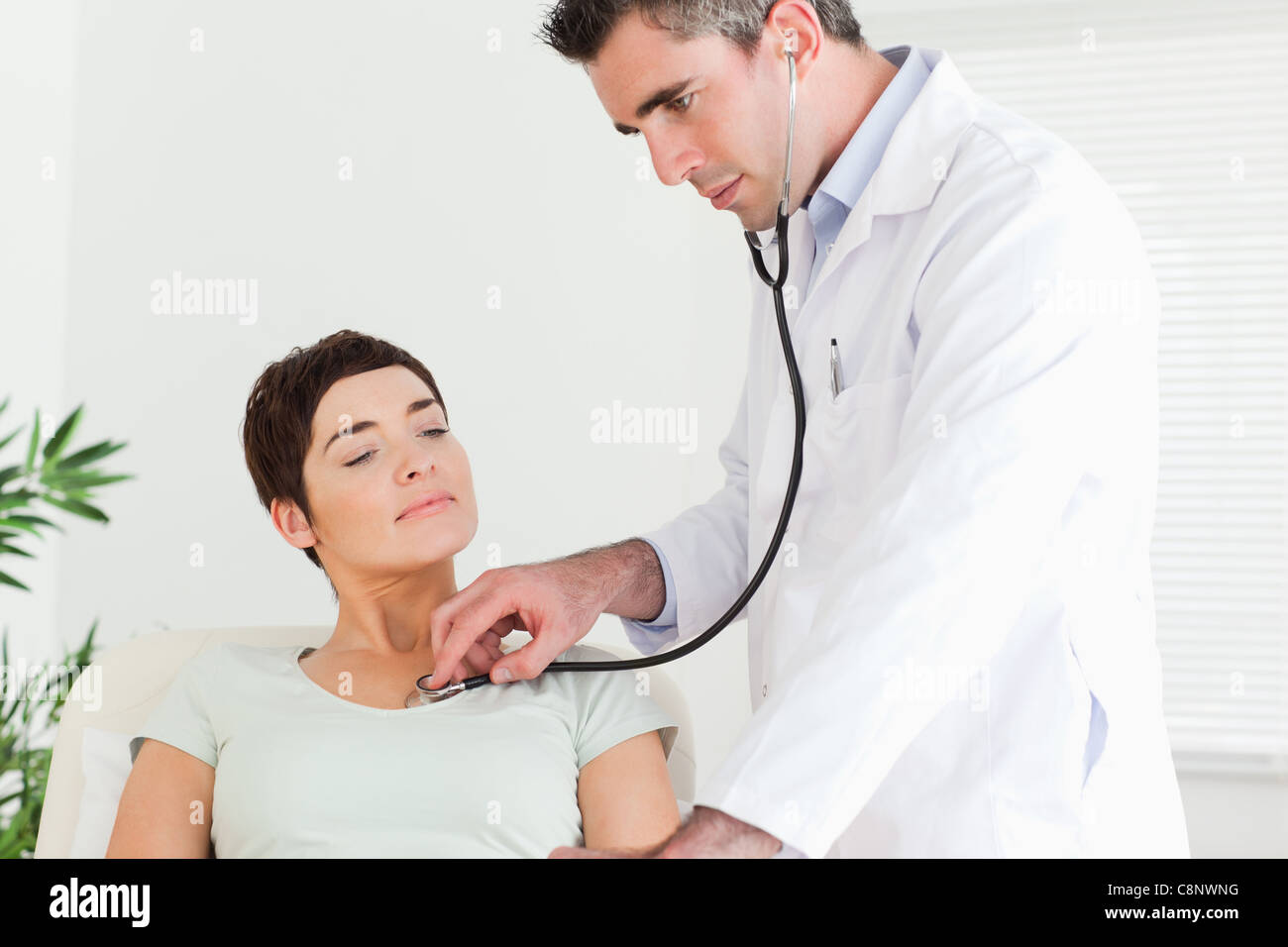 Doctor examining a patient Stock Photo - Alamy