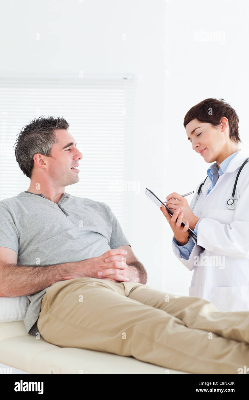 Female doctor talking to a male patient Stock Photo - Alamy