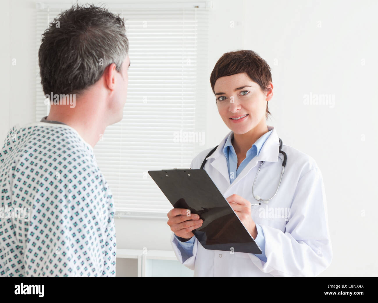 Female Doctor talking to a patient Stock Photo - Alamy