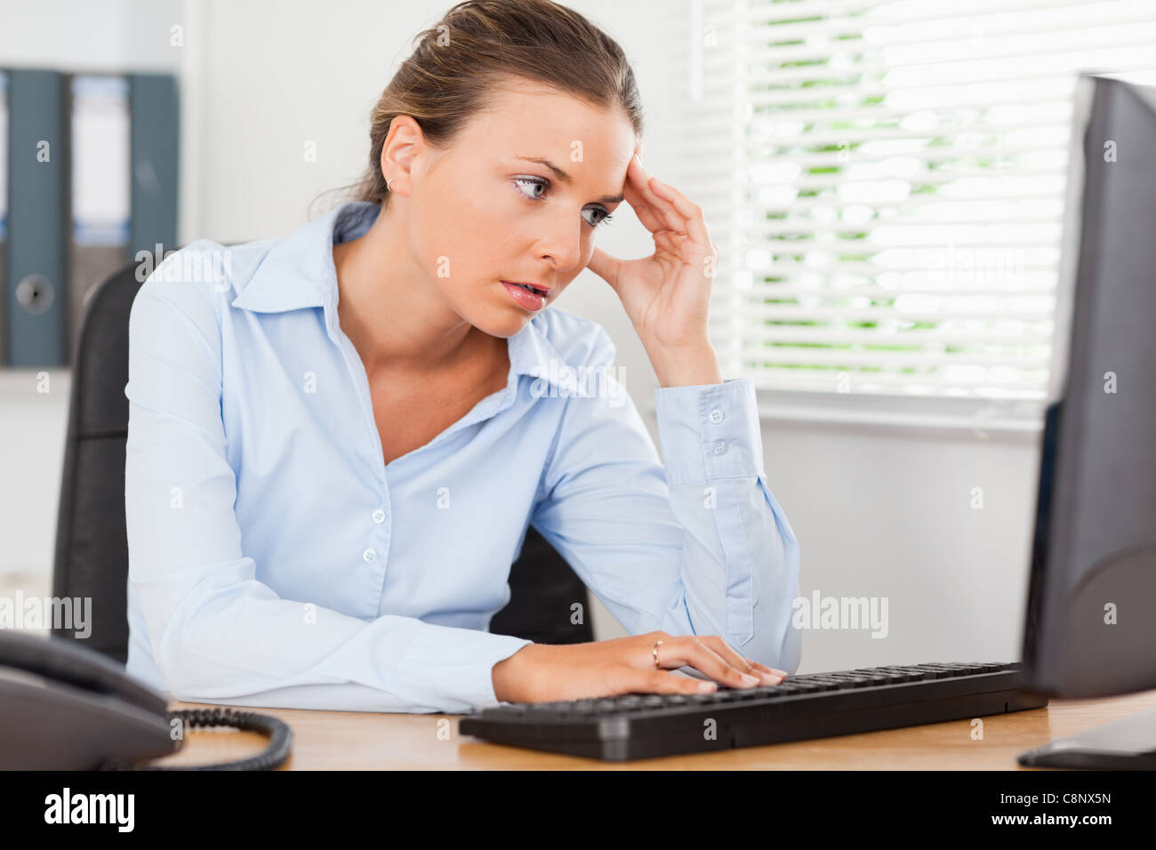 Frustrated woman looking to screen of pc Stock Photo - Alamy