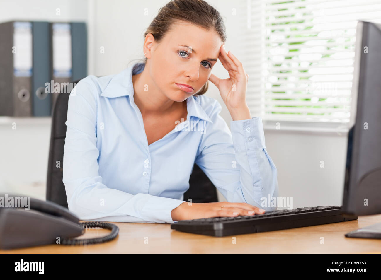 Sad businesswoman in an office Stock Photo - Alamy