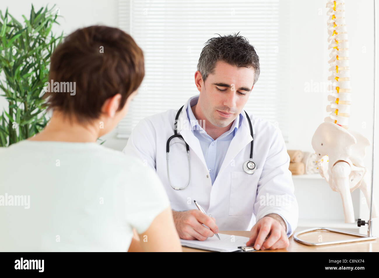 Doctor writing something down hi-res stock photography and images - Alamy