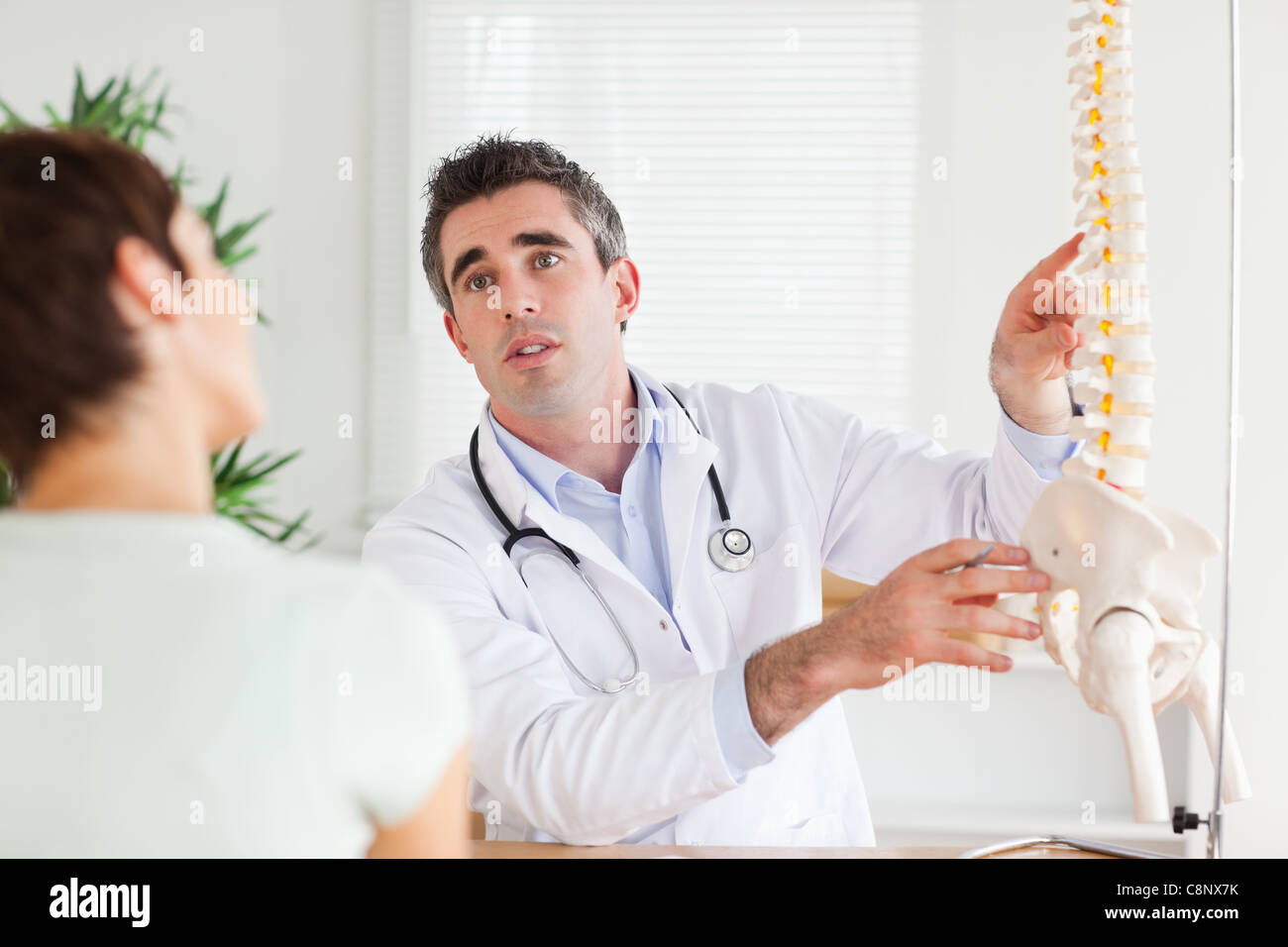 Male Doctor explaining something to a woman Stock Photo - Alamy