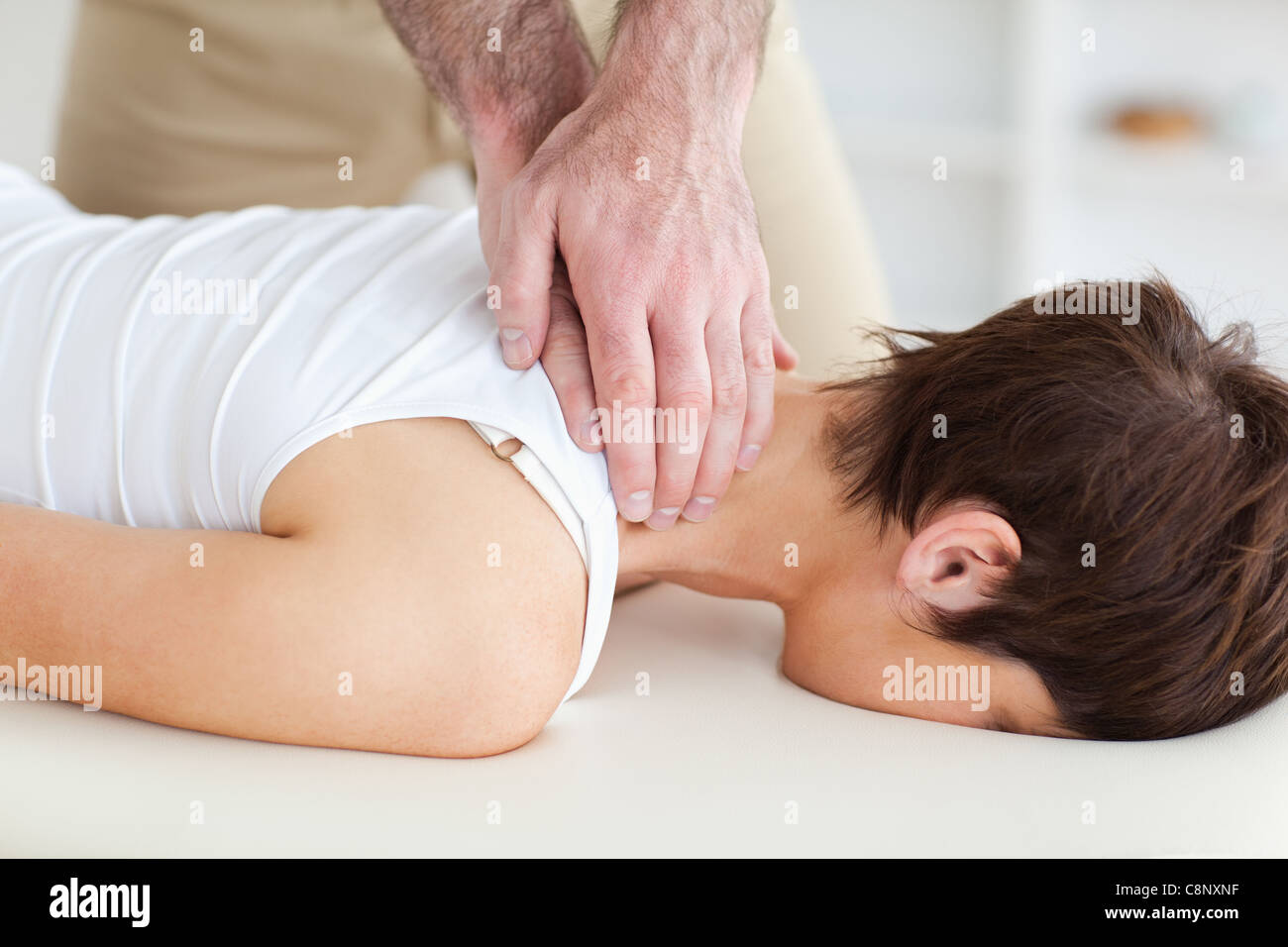 Masseur massaging customer's neck Stock Photo - Alamy