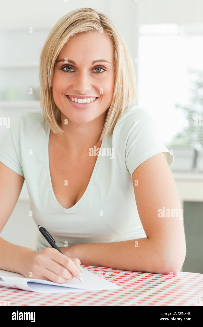 Cute woman proof-reading a text smiles into camera Stock Photo - Alamy