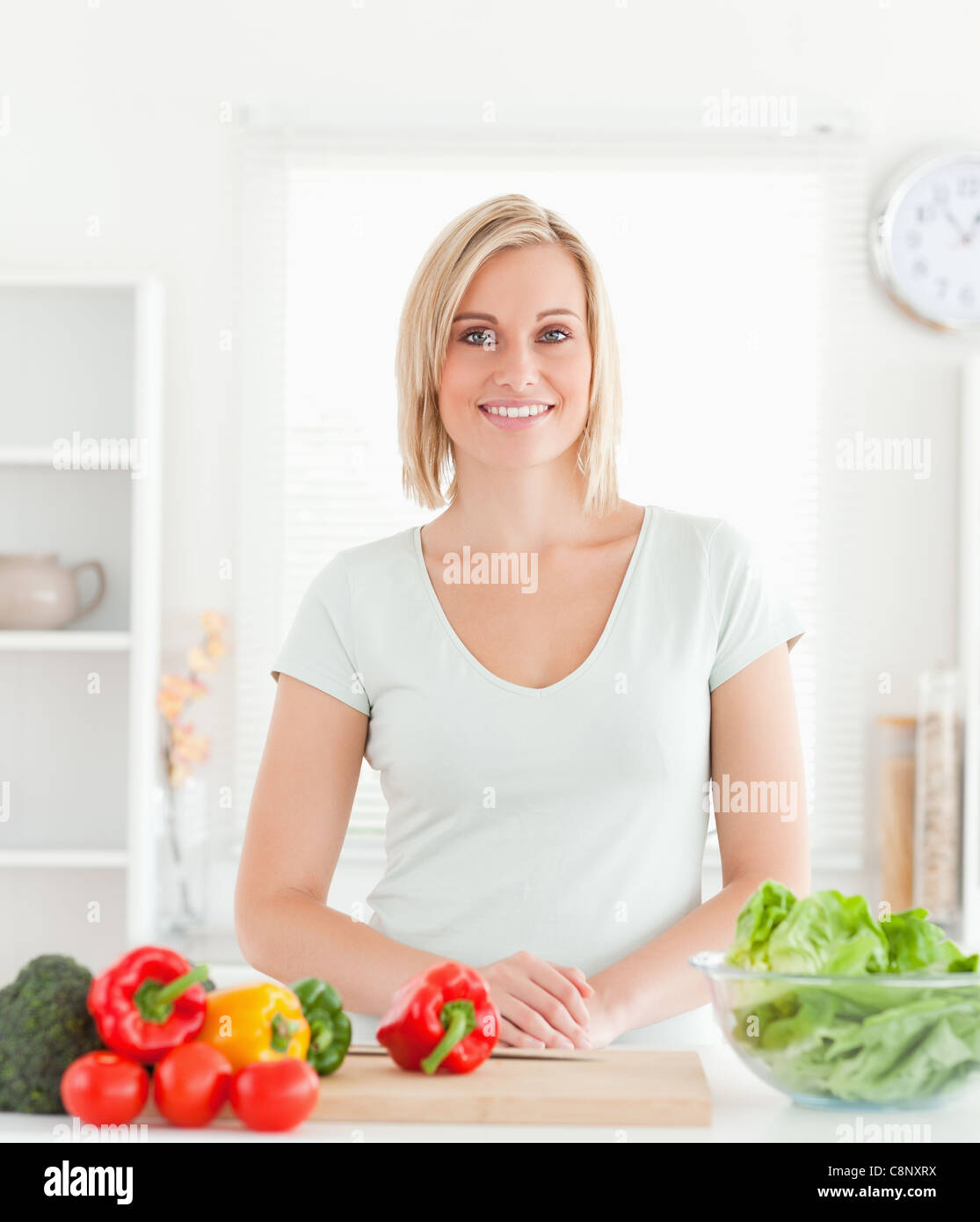 Young woman standing in kitchen Stock Photo - Alamy