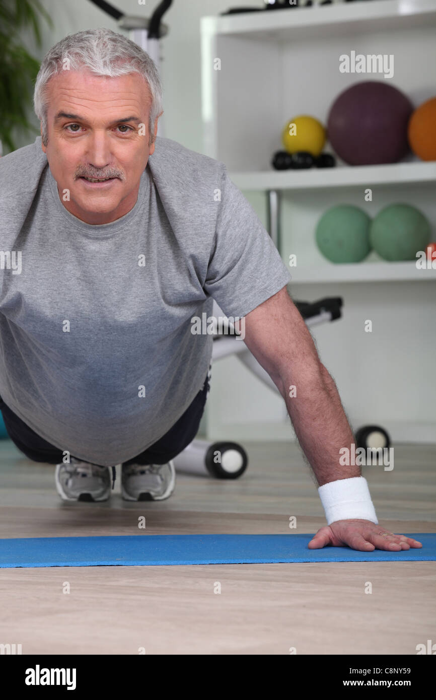 Mature man doing press ups Stock Photo - Alamy