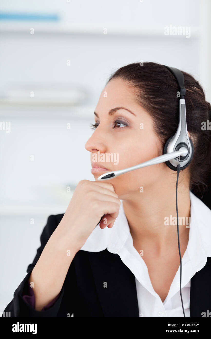 Thoughtful young operator looking away Stock Photo - Alamy