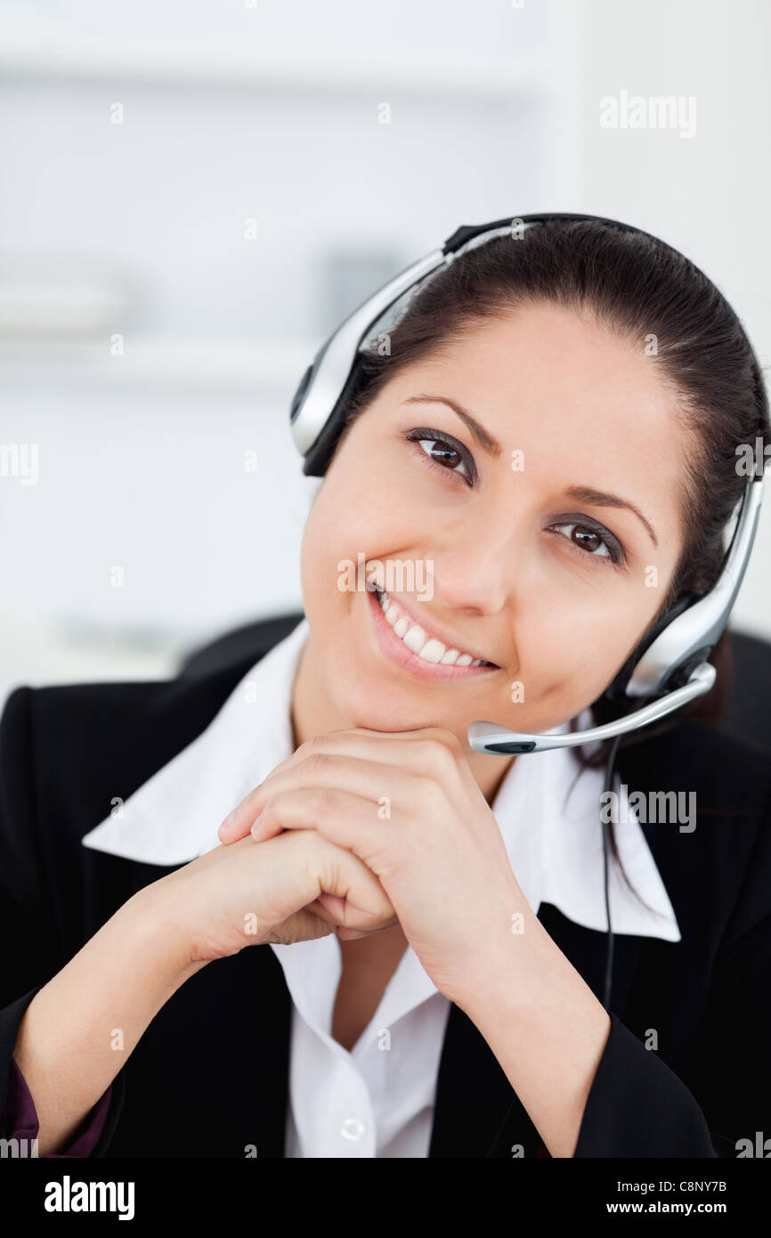 Smiling operator with headset in her office Stock Photo - Alamy