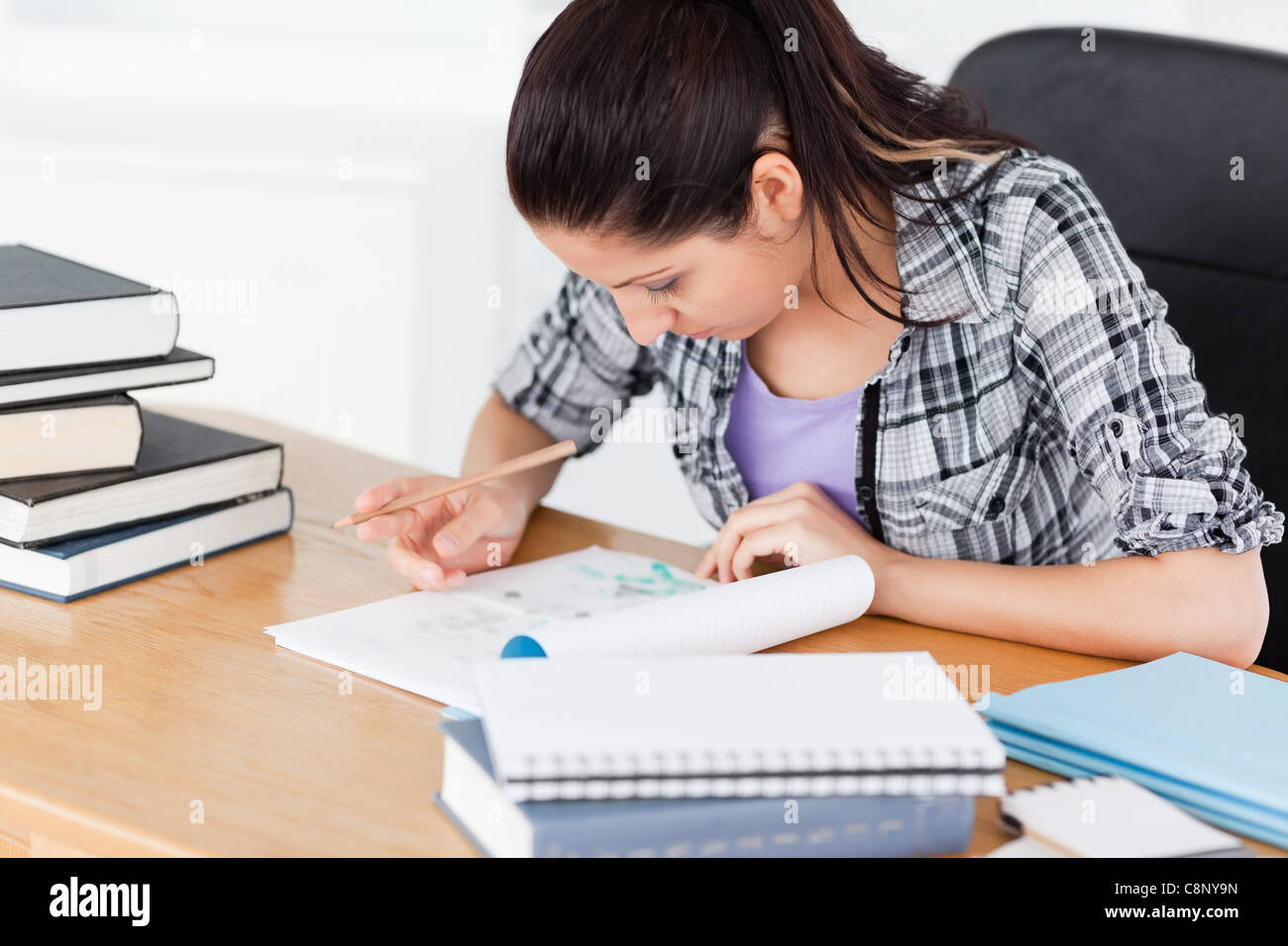 Young student doing homework Stock Photo - Alamy