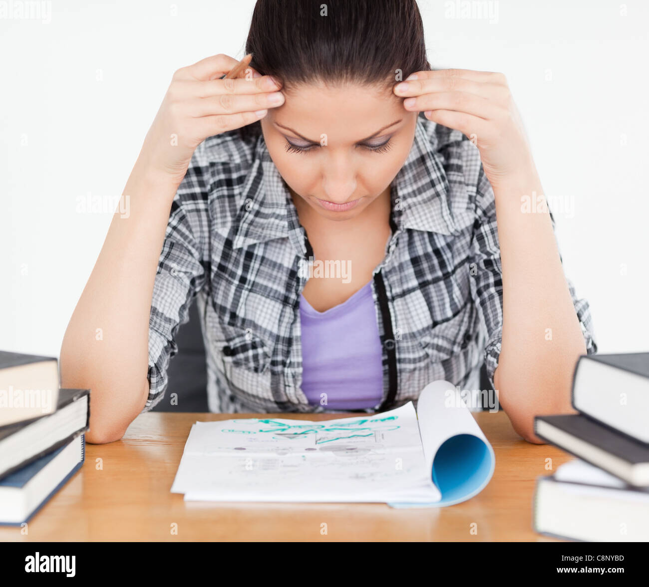 Stressed student doing her homework Stock Photo - Alamy